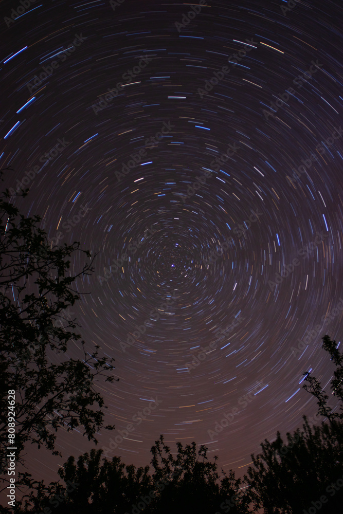 Colored star trails in the night sky around the North Pole and Polaris ...