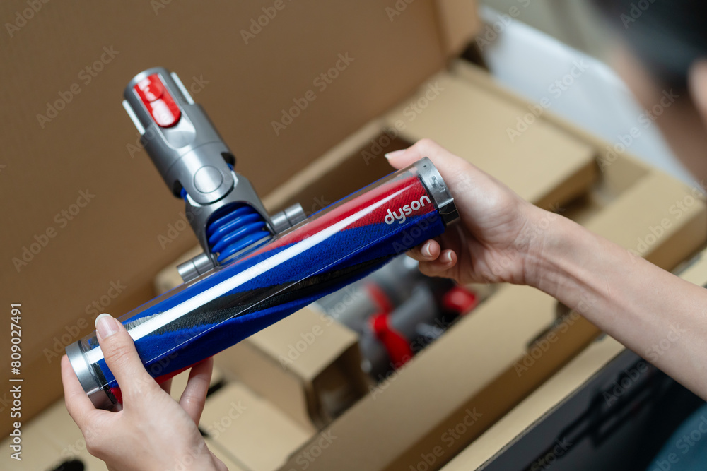 PENANG, MALAYSIA - APR 01, 2024: Lady's hand holding the slim fluffy ...
