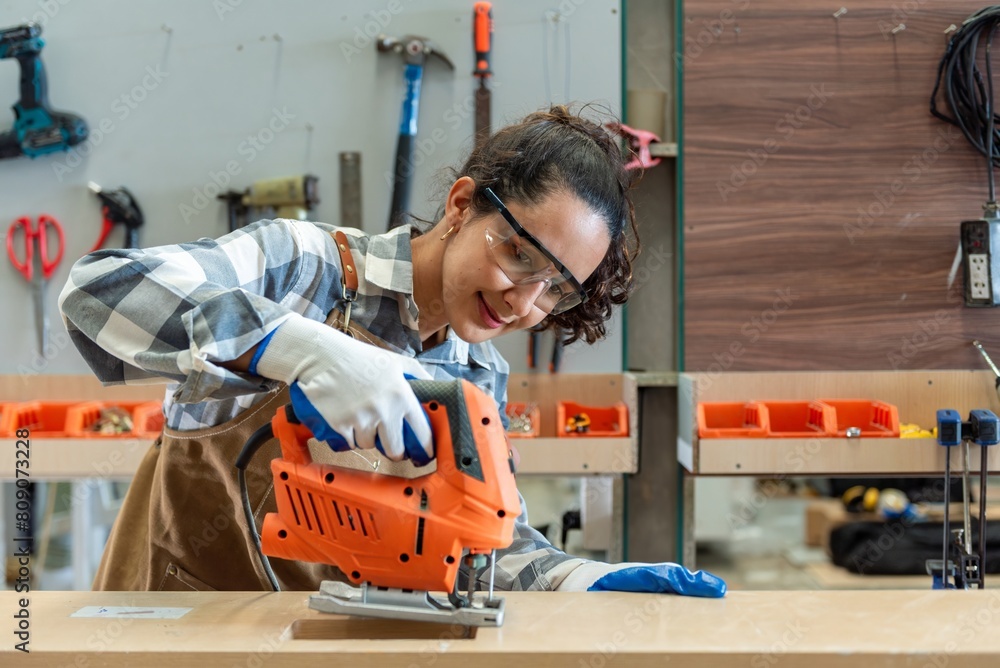Carpenter woman one smile young aged standing aim working on wood plank ...