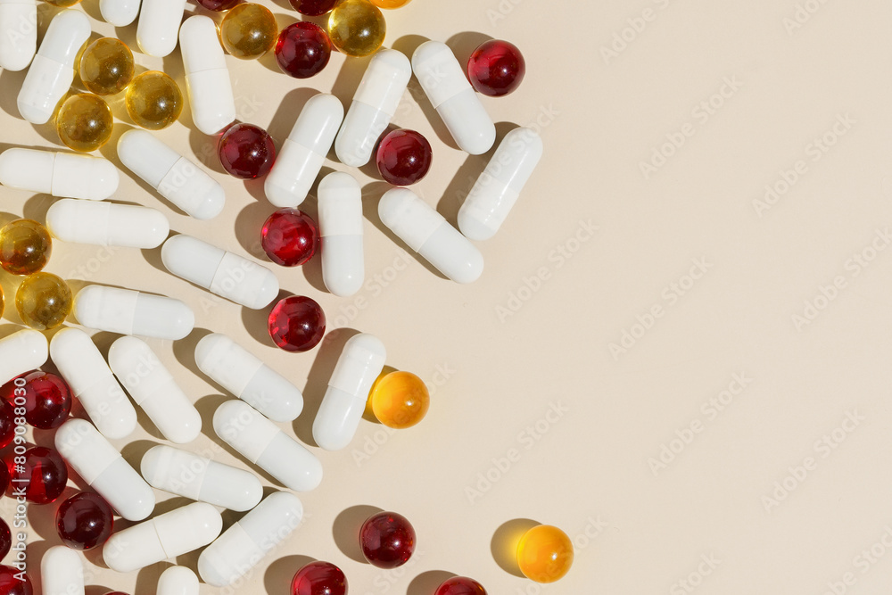White and transparent capsule pills on beige isolated background ...