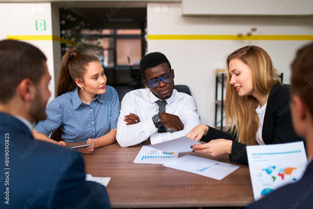 Diverse corporate team in office engage in analytics. Global staff ...