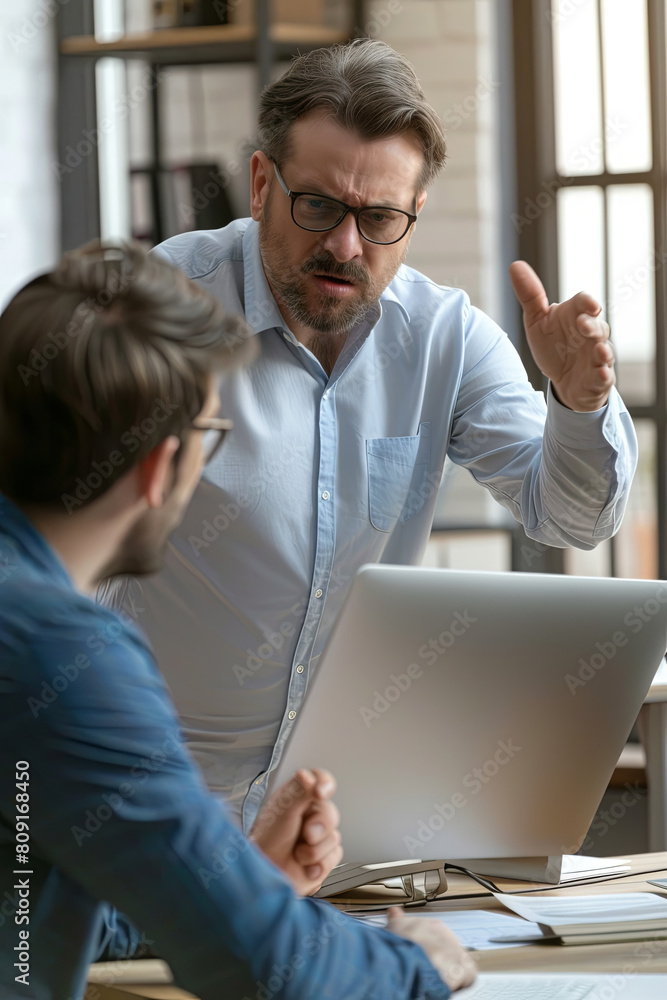 Angry boss criticizing scolding sad male employee for computer mistake ...