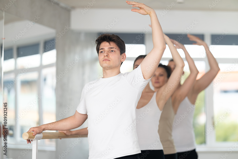 Motivated sporty young guy in white t-shirt and black sweatpants ...