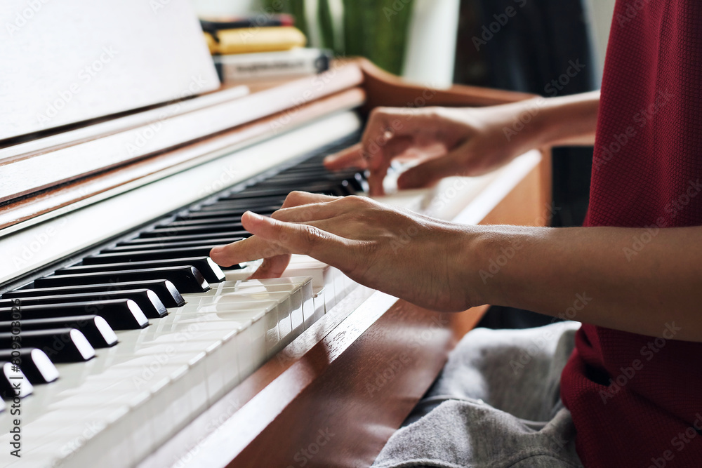 Hands of woman playing grand piano in musical school.Two hand with ...