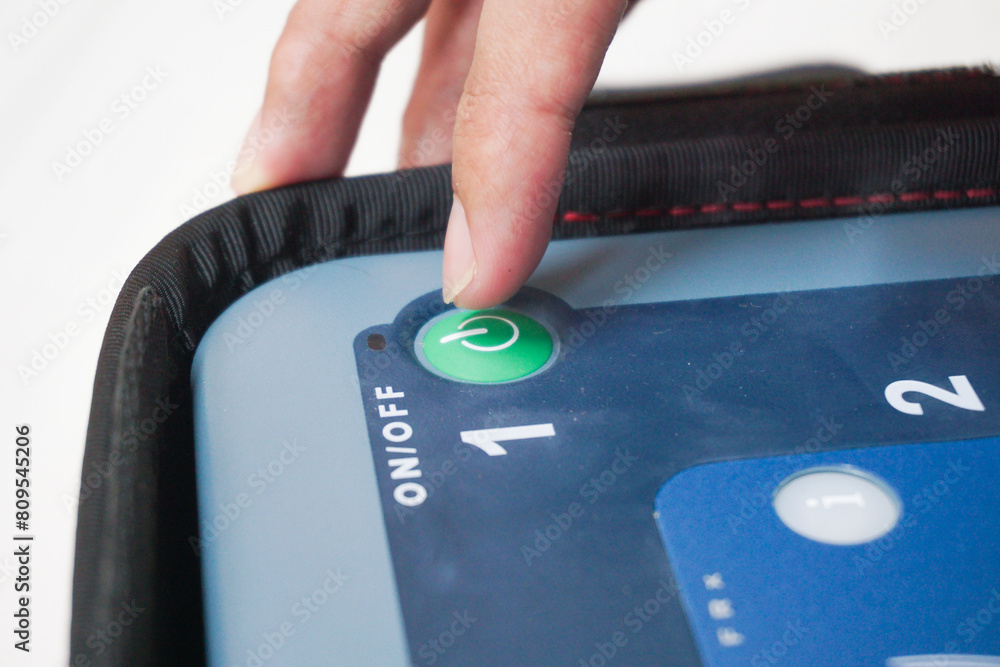 pressing the AED power button to turn it on and use a patient in ...