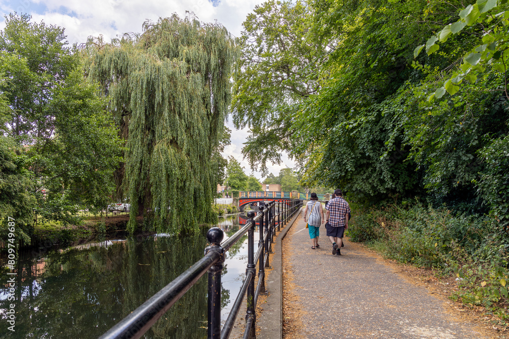 Family walk by Little Ouse River Thetford with cast iron bridge and ...