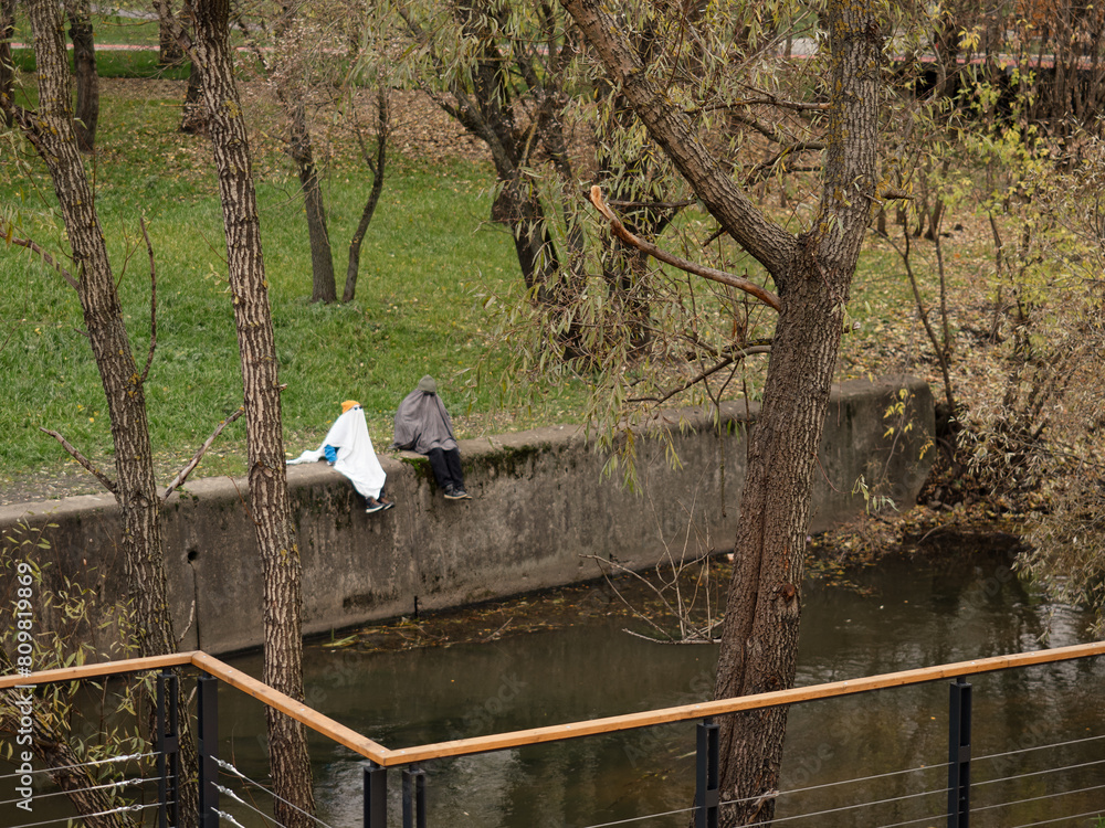 Two boys dressed as ghosts in grey and white sheets, Halloween ...