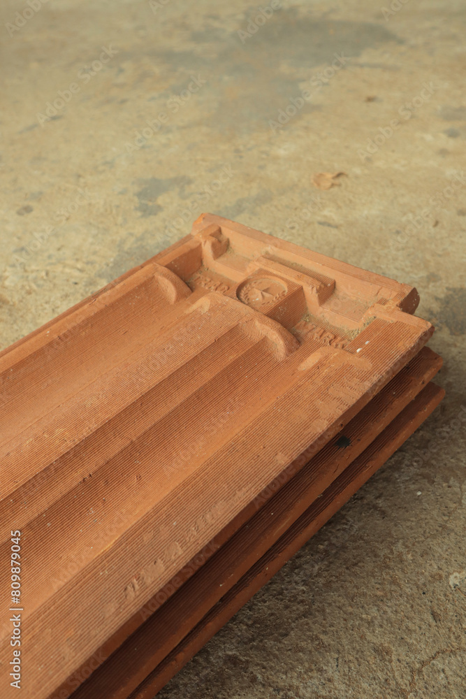 Stack of clay roof tiles in a construction site. Building materials ...