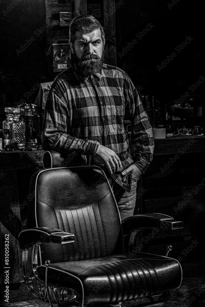 Portrait of a barber sitting in a barber's chair in his workplace. Man ...