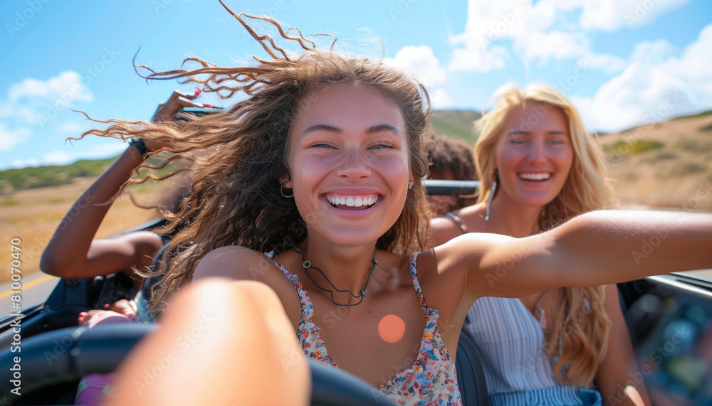 showing friends on a road trip, taking a selfie in an open convertible ...