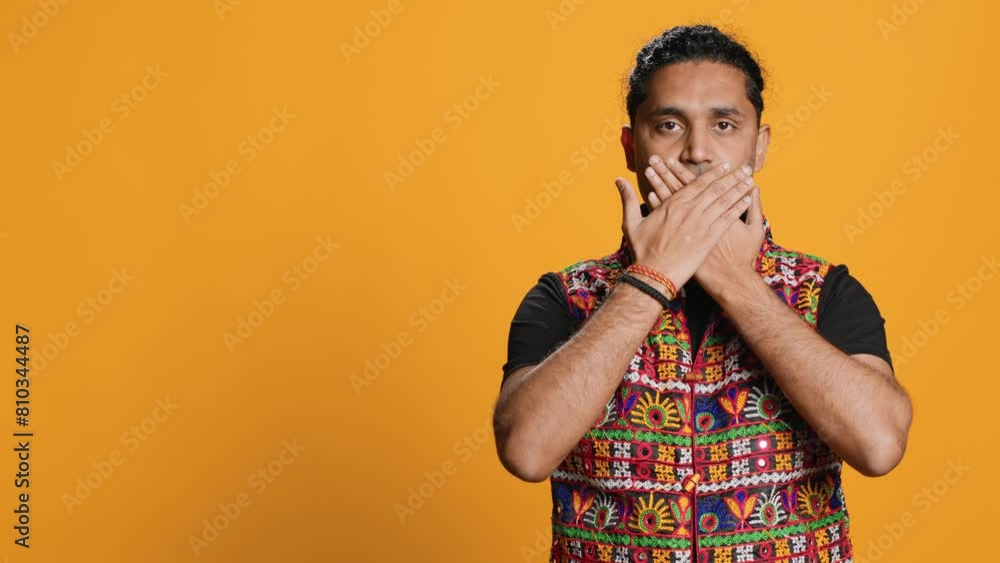 Indian man covering eyes, ears and mouth with hands, imitating the ...