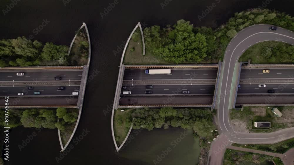 Steady top down aerial view of submerged highway with traffic passing ...
