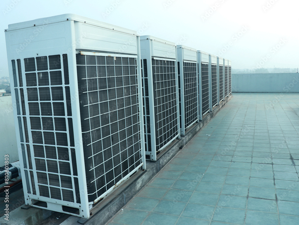 Rows of rooftop HVACs on the rooftop of an office tower. VRF air ...