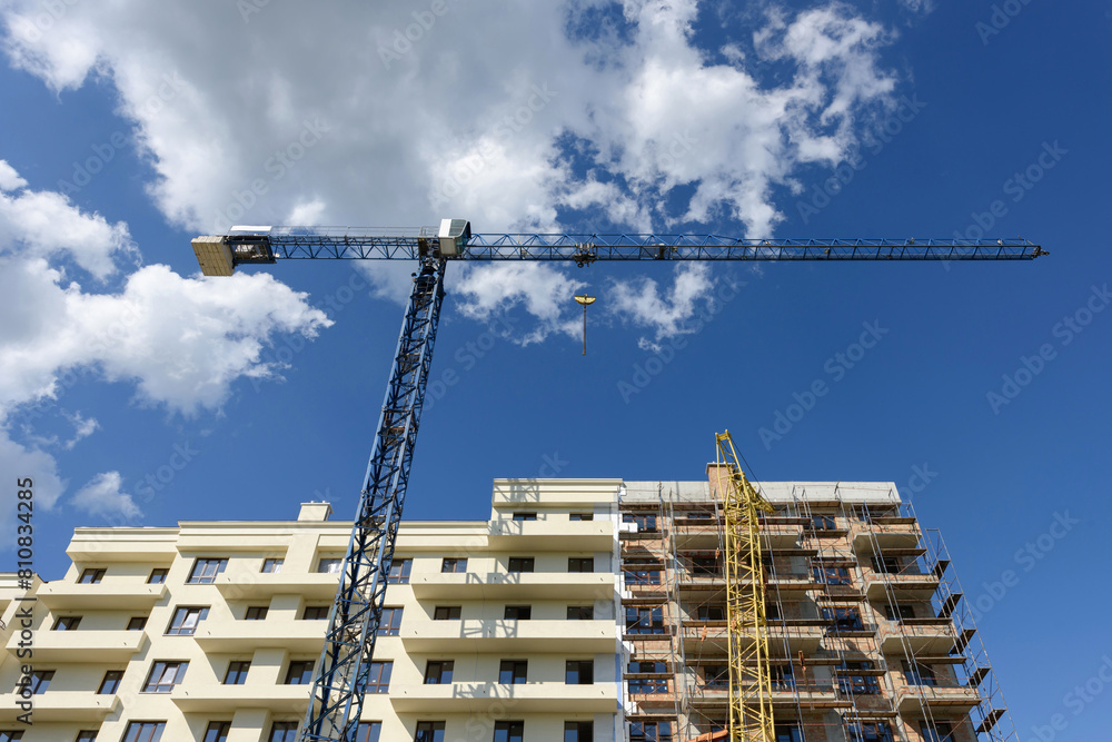Construction crane against the sky. Tall blue tower crane. Construction ...