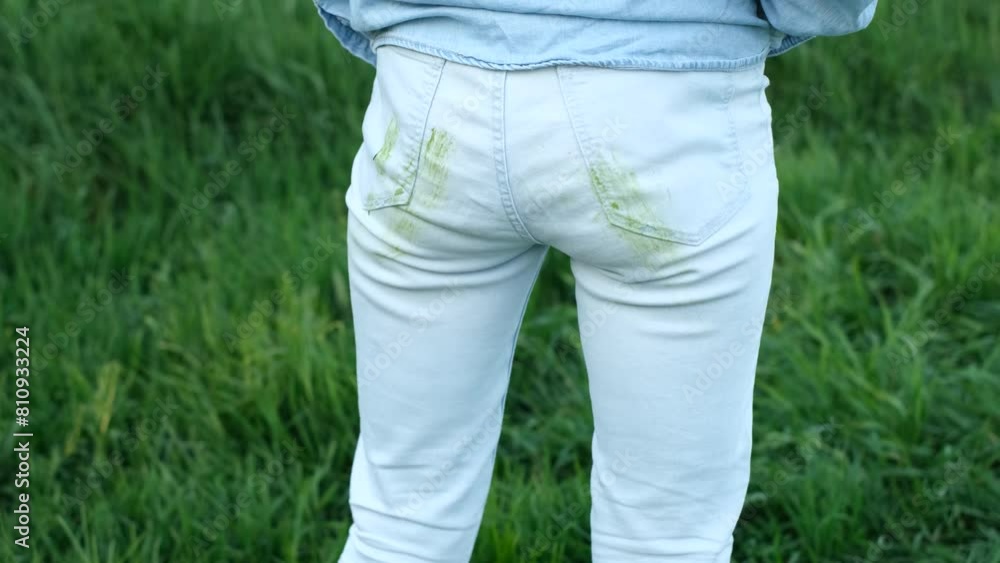 Close up dirty grass stains on white clothes. An unrecognizable person ...