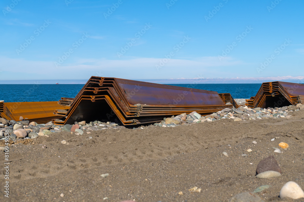 Metal Larsen sheet piles or Larsen piles stacked in stack. Sheet piles ...