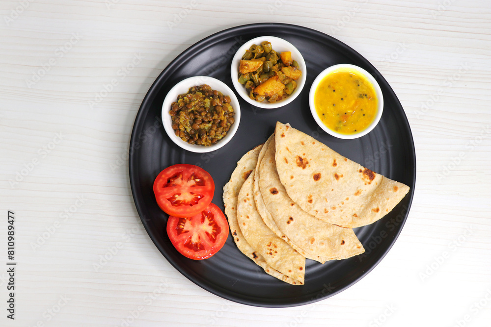 Roti and bhaji. Indian vegetarian Thali or platter includes akhha ...
