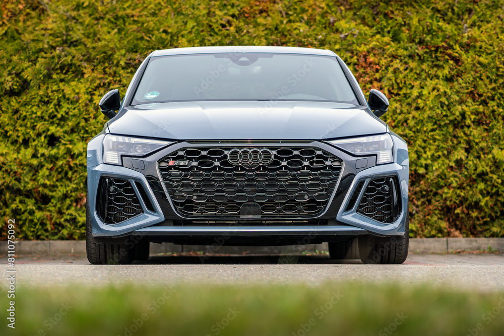 Audi RS3 sports car in gray is parked outside in a parking lot in front ...