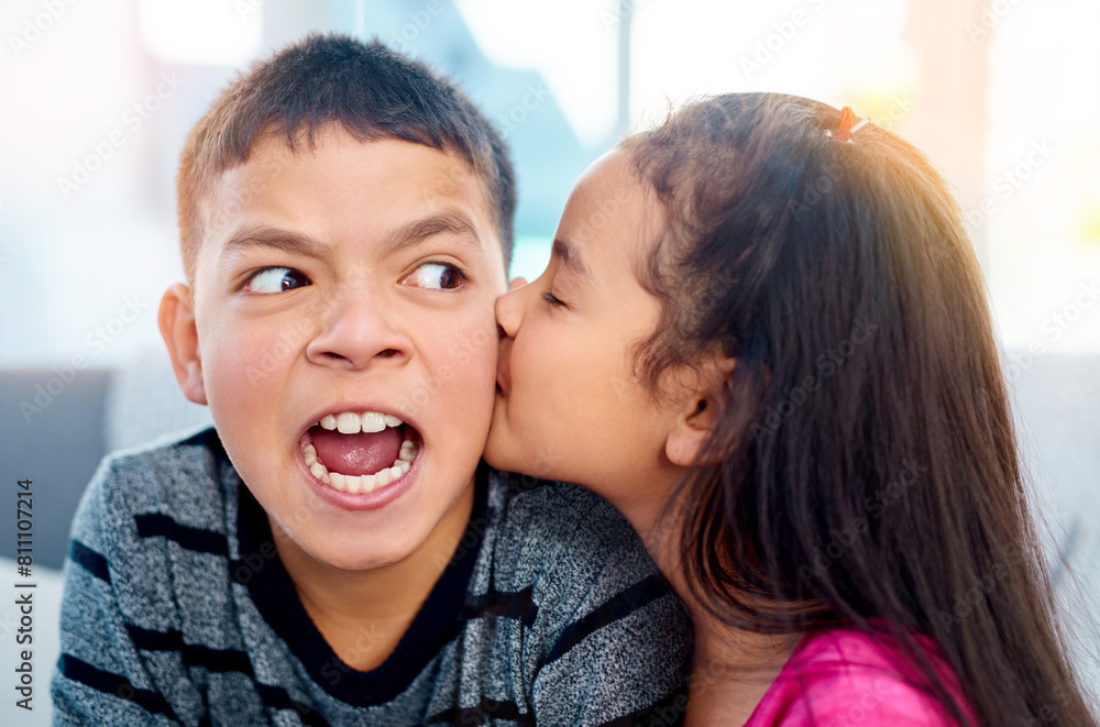 Young, children and annoyed in kiss on cheek with cute in home as kids ...