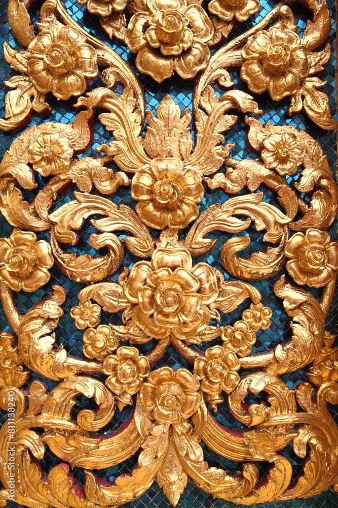 Ancient traditional Thai style wall decorated with colorful glass and ...