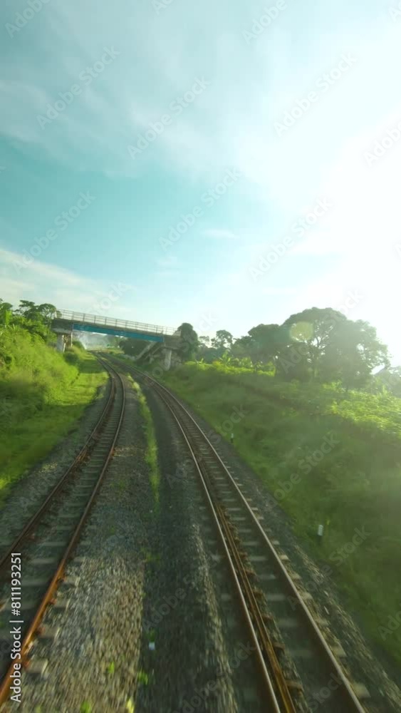 fpv drone view of passes over train tracks in the countryside and there ...