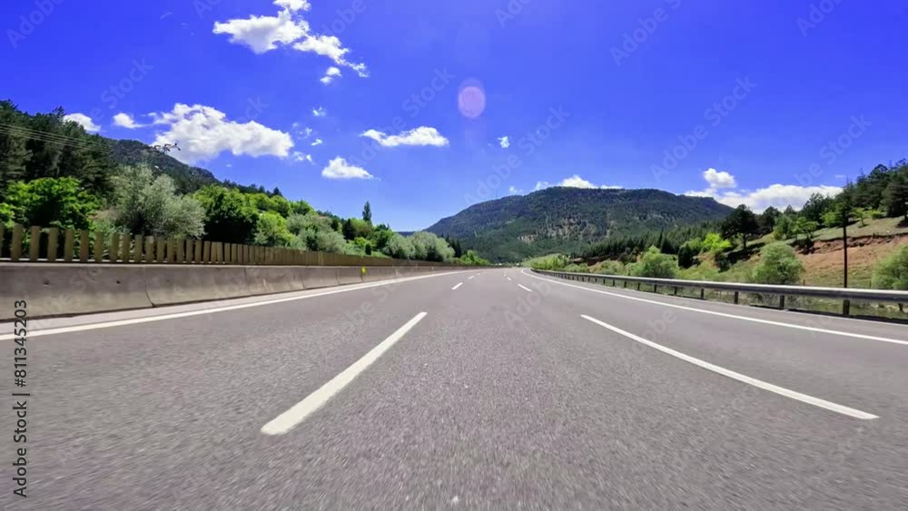 A breathtaking view of a highway weaving through lush forests with ...