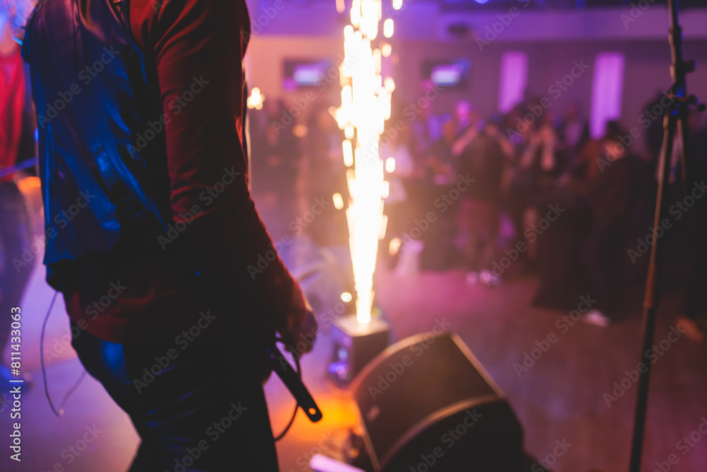Concert view of an electric guitar player with vocalist and rock band ...