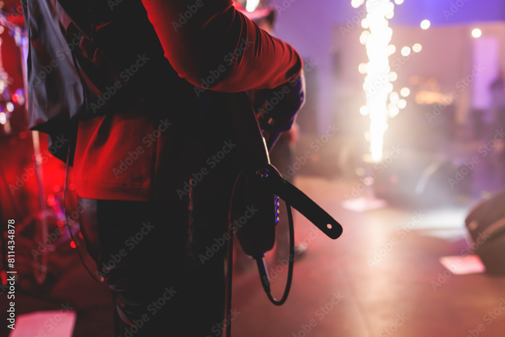 Concert view of an electric guitar player with vocalist and rock band ...