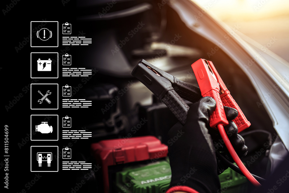 Hand car mechanic holding car booster cables with car care service ...