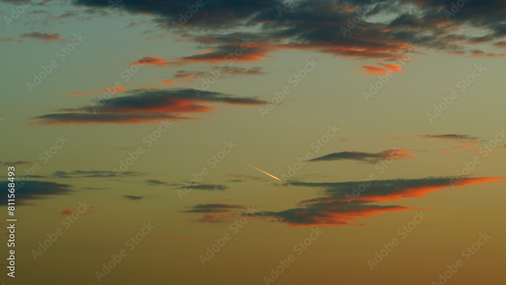 Airplane High In The Sunset Sky. Plane With Vapor Stripes. Diagonal ...