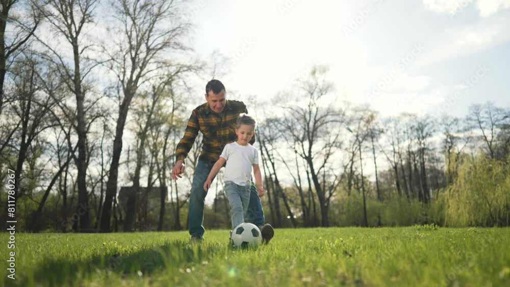 Father teaches son to play soccer. Happy father and son bonding on ...
