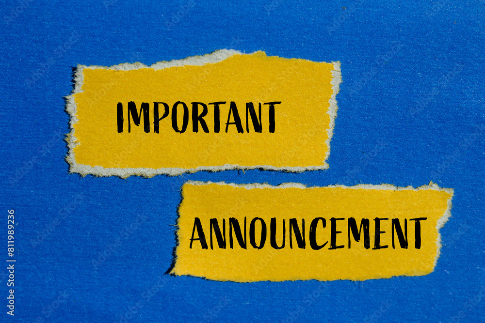 Important announcement words written on ripped yellow paper pieces with ...