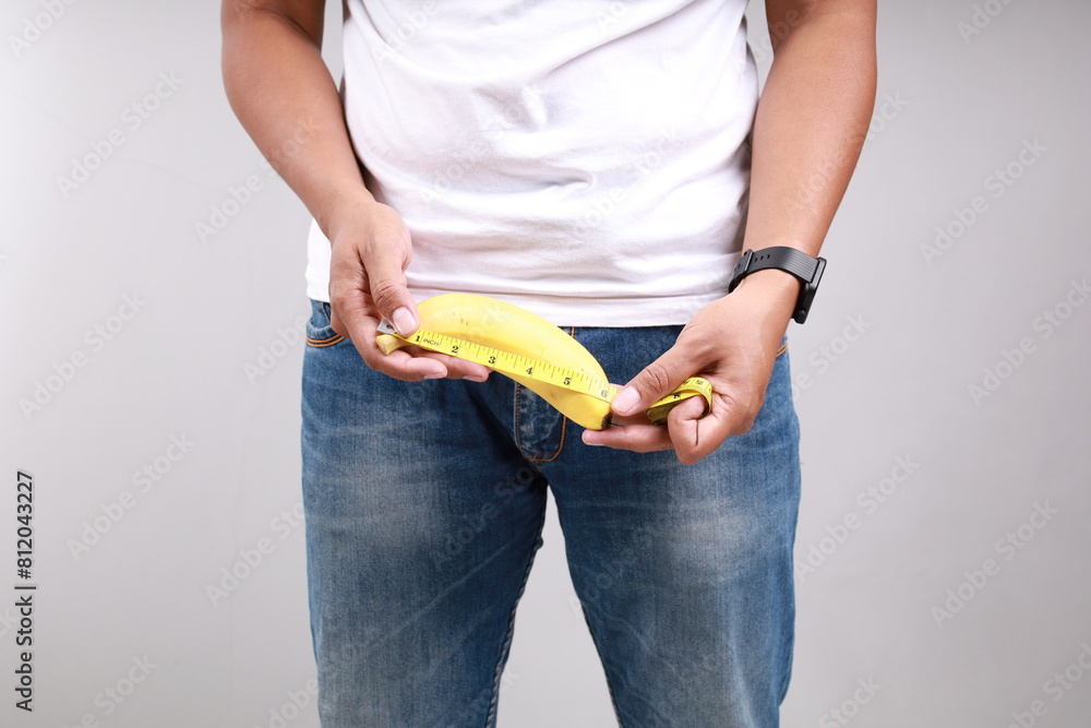 Asian man measuring a banana using tape measure on his crotch. Size ... Asian man measuring a banana using tape measure on his crotch. Size ...