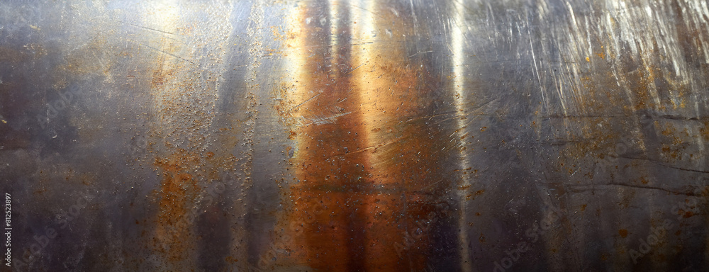 Aged metal with a patina of rust and weathering under natural light ...