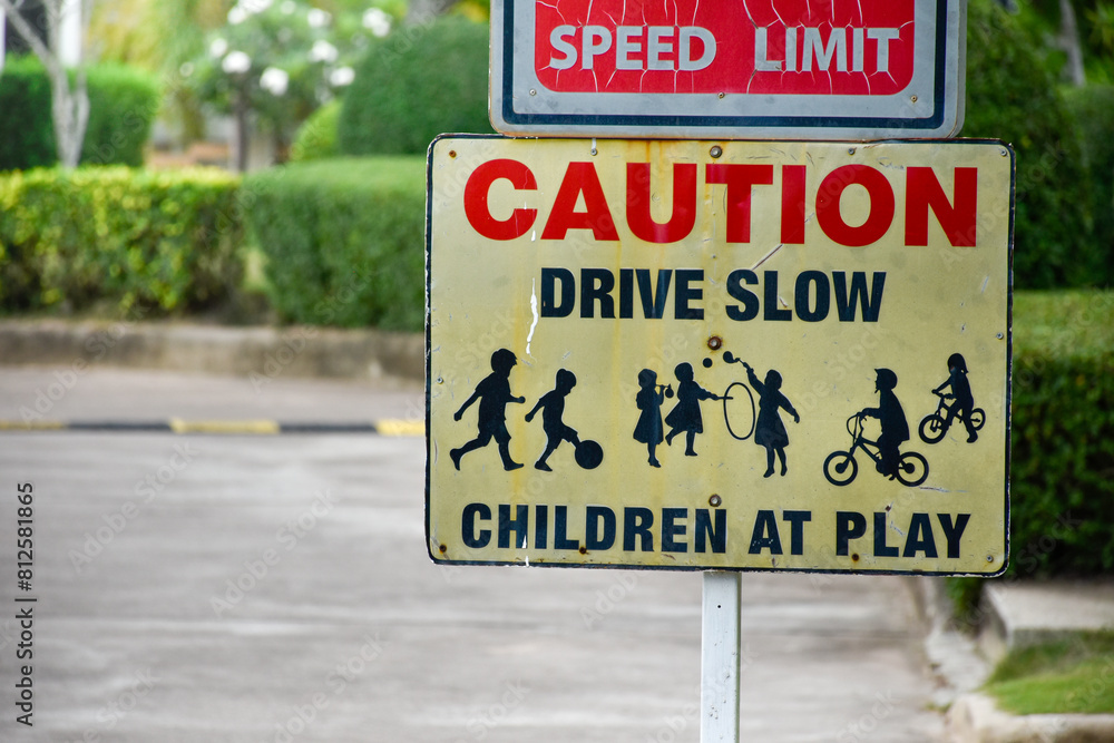Sign caution speed limit drive slow children at play on yellow ...