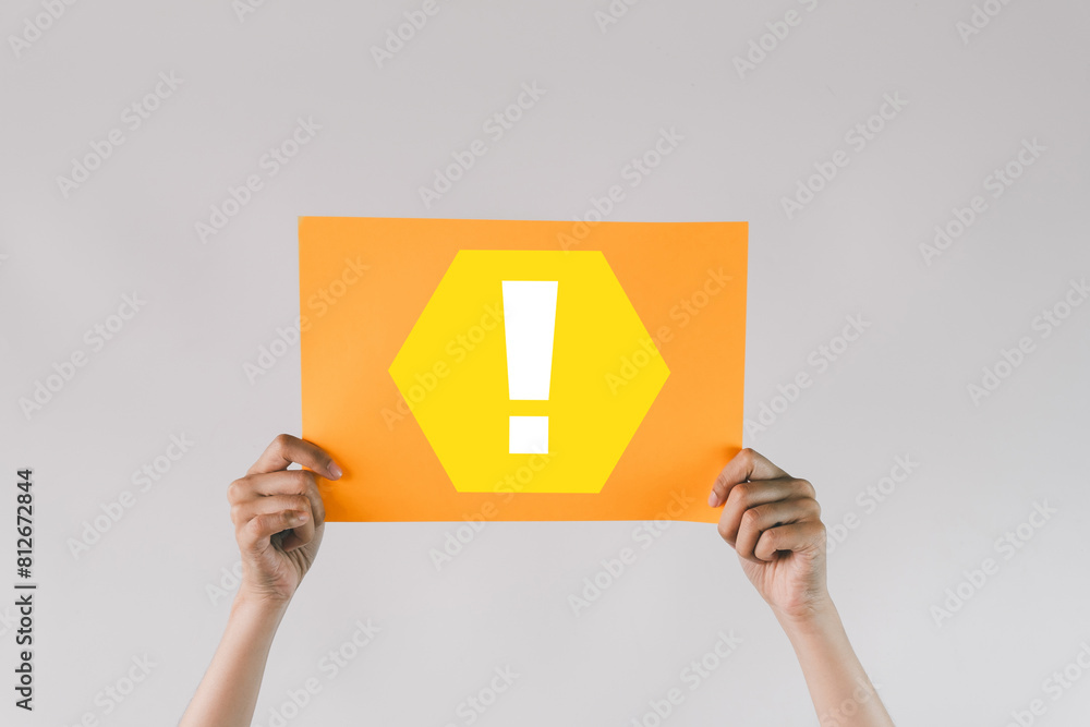 Hand show orange paper with Exclamation mark used to attention to ...
