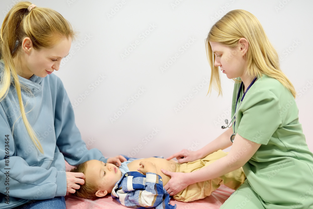 Cute toddler boy is at an appointment with pediatrician. Doctor ...