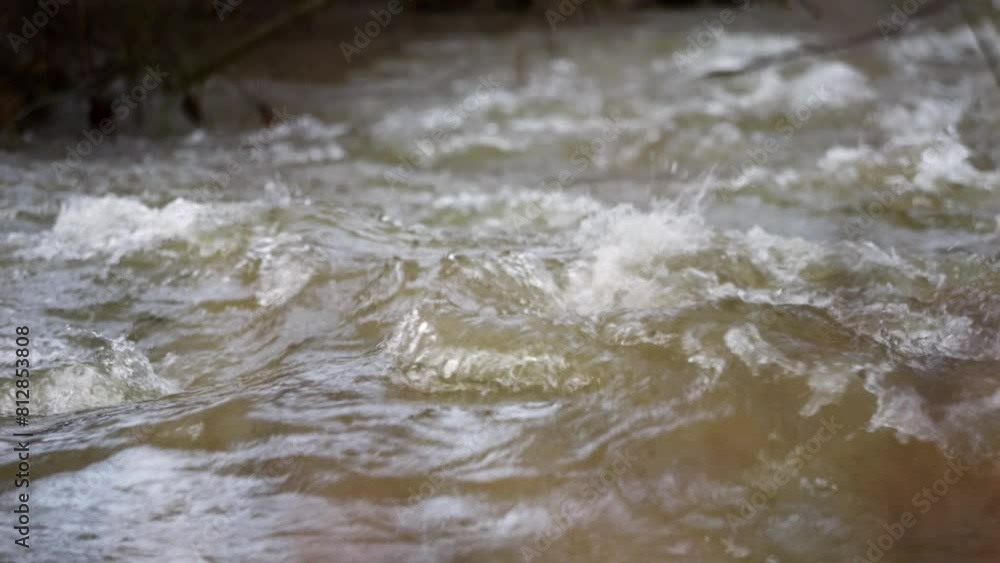 Water flow of a stream during a rain period carrying a lot of dirty ...
