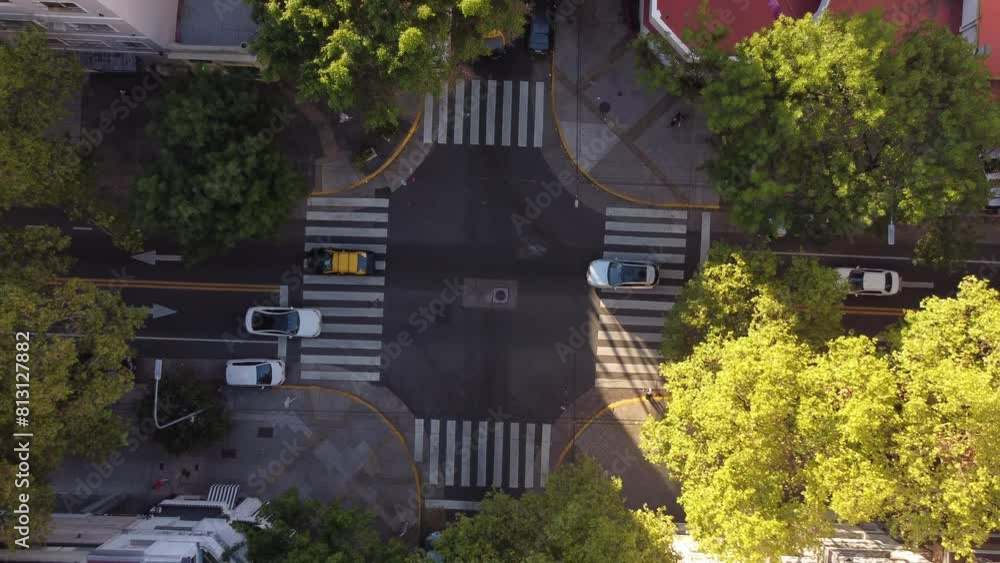 Cars passing through intersection with road safety paint, traffic ...