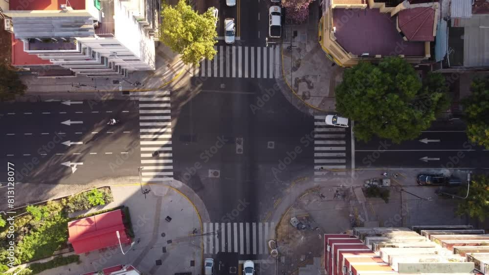 Cars passing through intersection with road safety paint, traffic ...