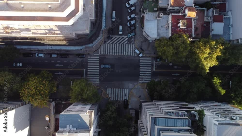 Cars passing through intersection with road safety paint, traffic ...