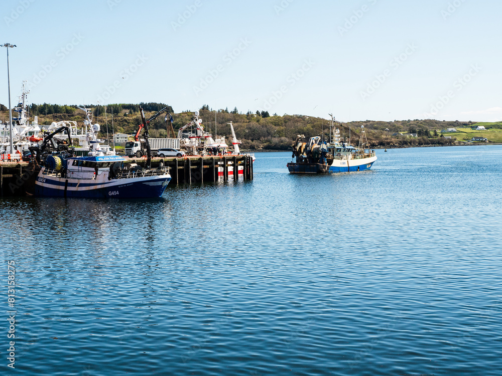 Killybegs village, Ireland - 04.21.2024: Small fish trawler approaching ...