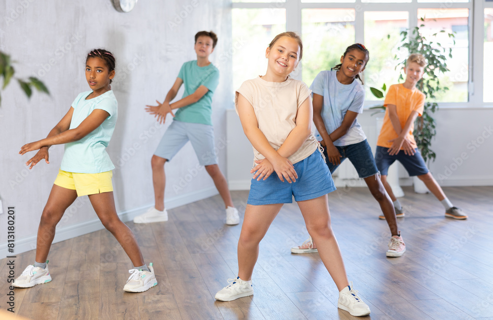 Positive girl dances hip hop in choreographic school, group of young ...