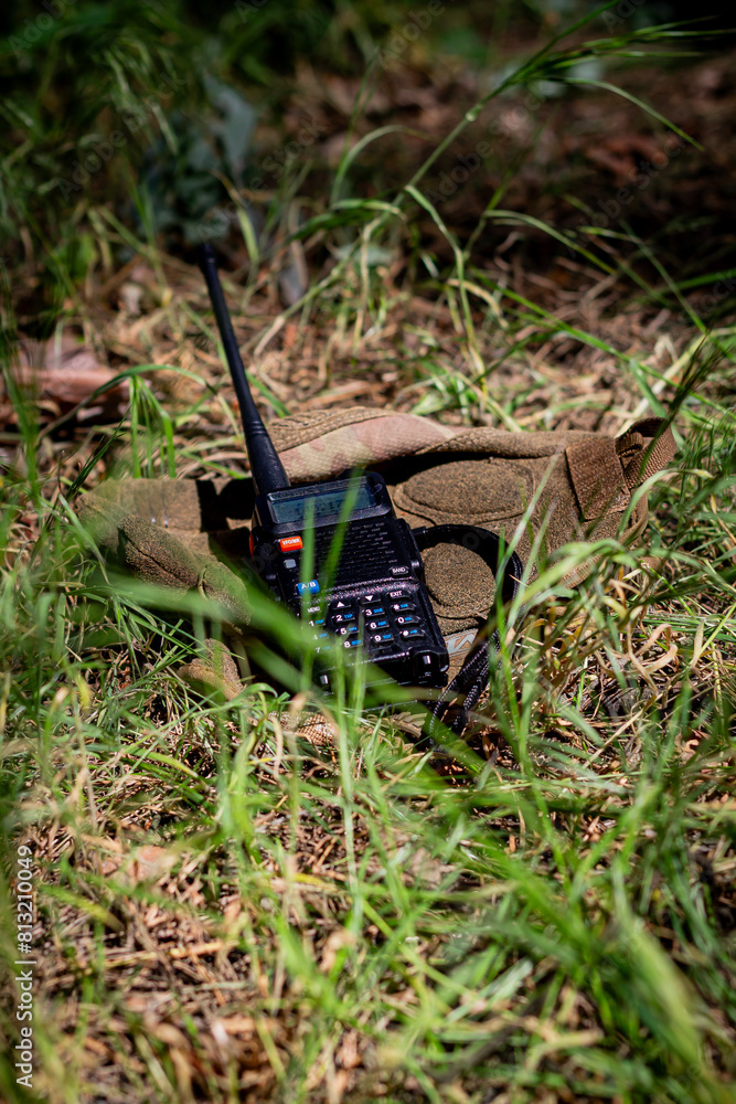 Military gear, tactical gloves and a walkie-talkie. Individual ...
