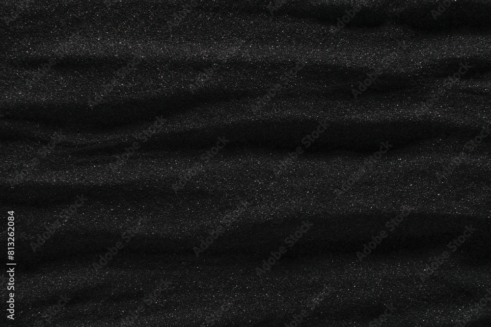 Dunes of dark black sand. Stripes and ripples of smooth volcanic sand ...