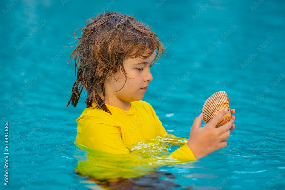 Happy child with sea shell at the beach. Summer vacations concept ...