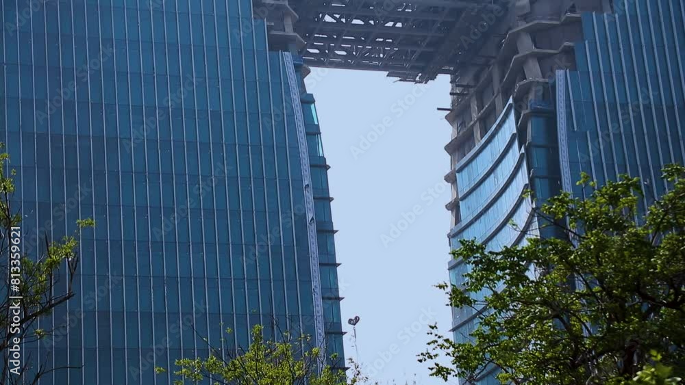 Construction site of a flyover connecting skyscrapers The finished ...