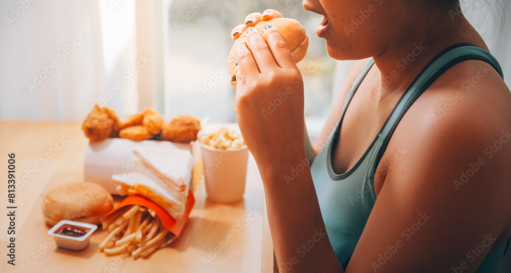Binge eating disorder concept with woman eating fast food burger, fired ...