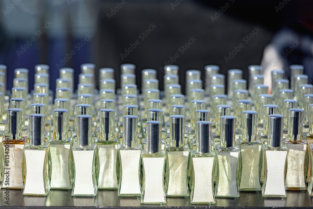Bottles of aromatic elite perfume on display in beauty store. Delicate ...
