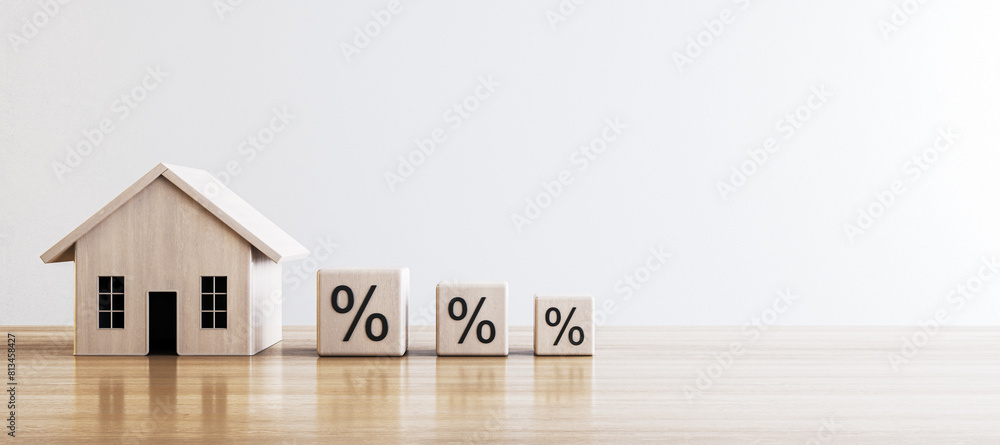 Wooden model house next to percentage blocks, financial concept of ...